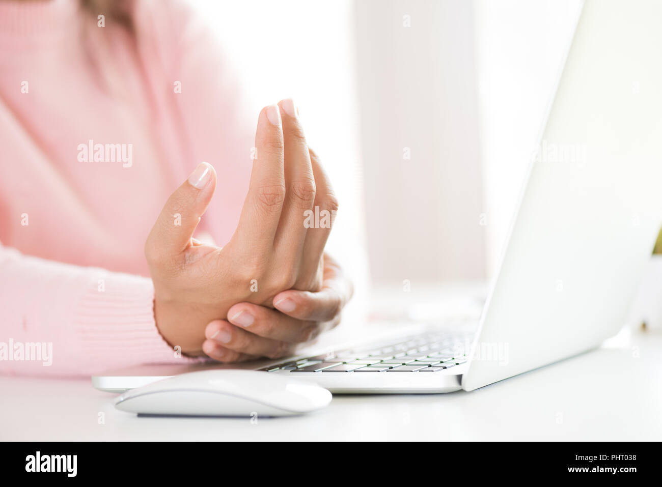 Closeup woman holding her wrist pain from using computer. Office ...