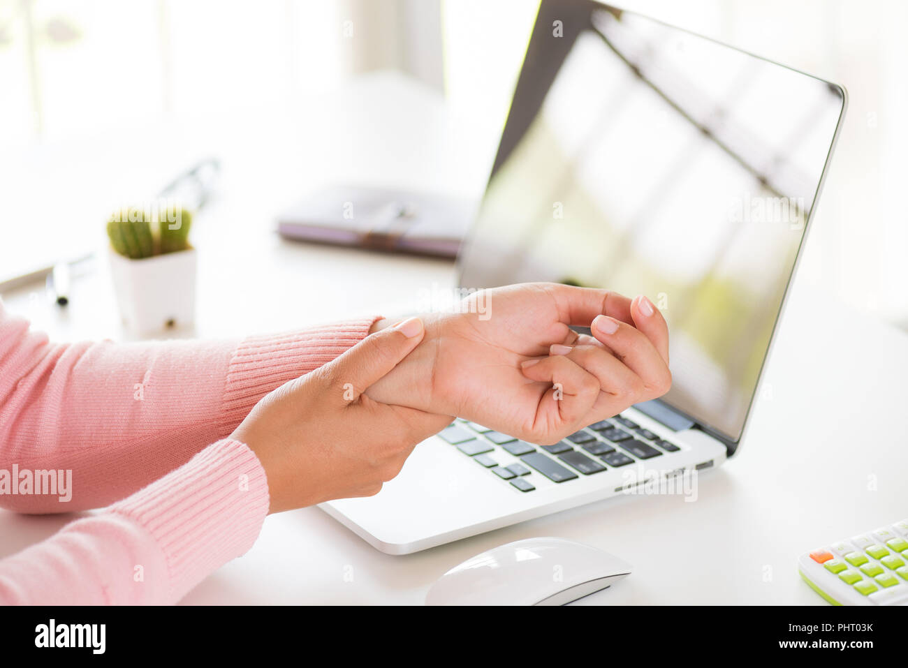 Closeup woman holding her wrist pain from using computer. Office ...