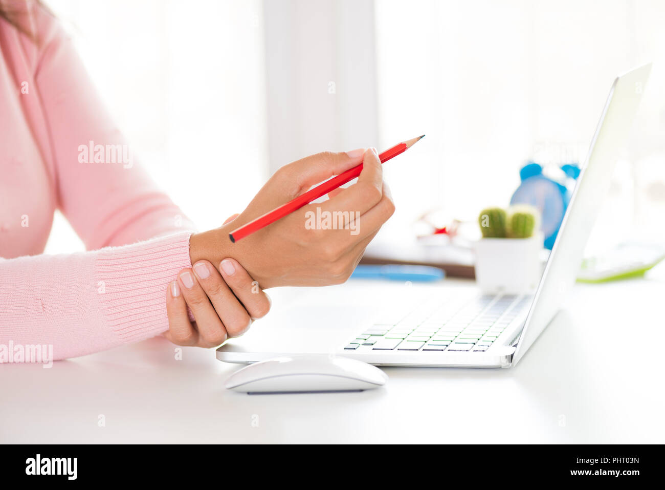 Closeup woman holding her wrist pain from using computer. Office ...
