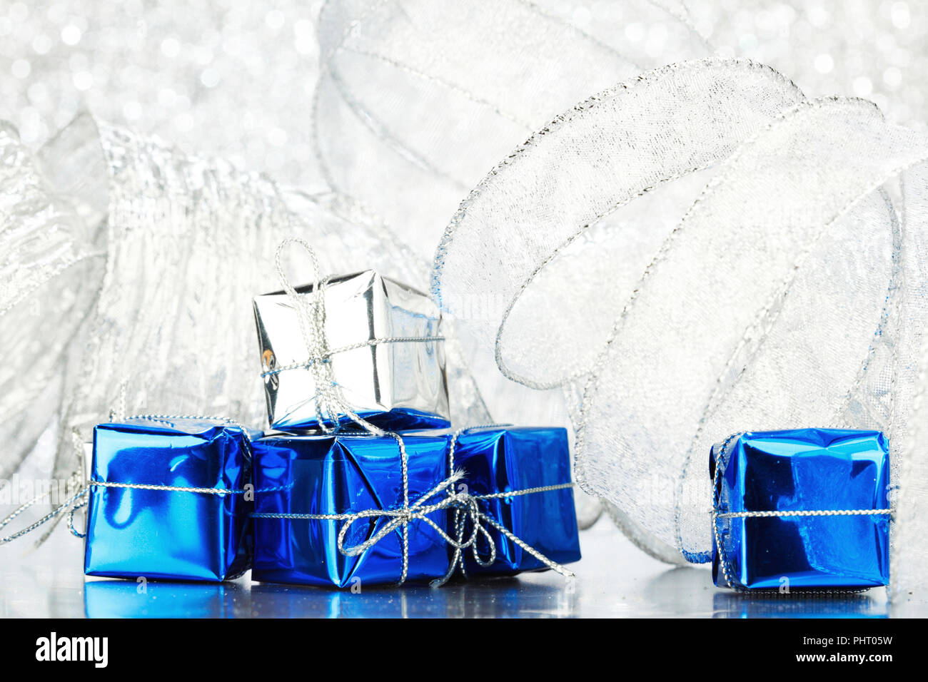 Decorative blue boxes with holiday gifts on shiny glitter background ...