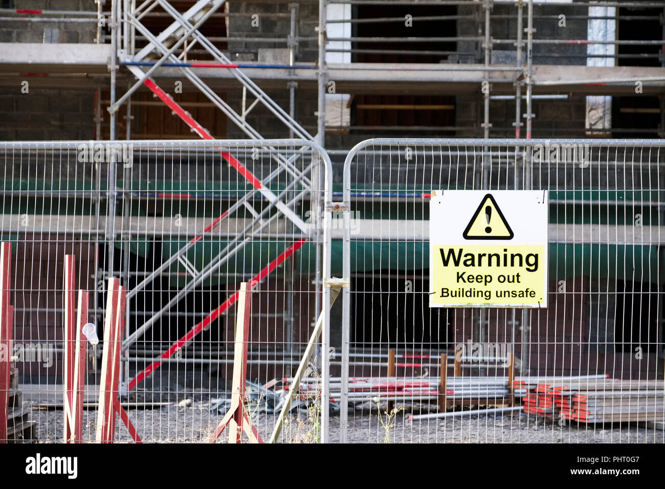 Unstable building keep out dangerous sign on fence at building ...