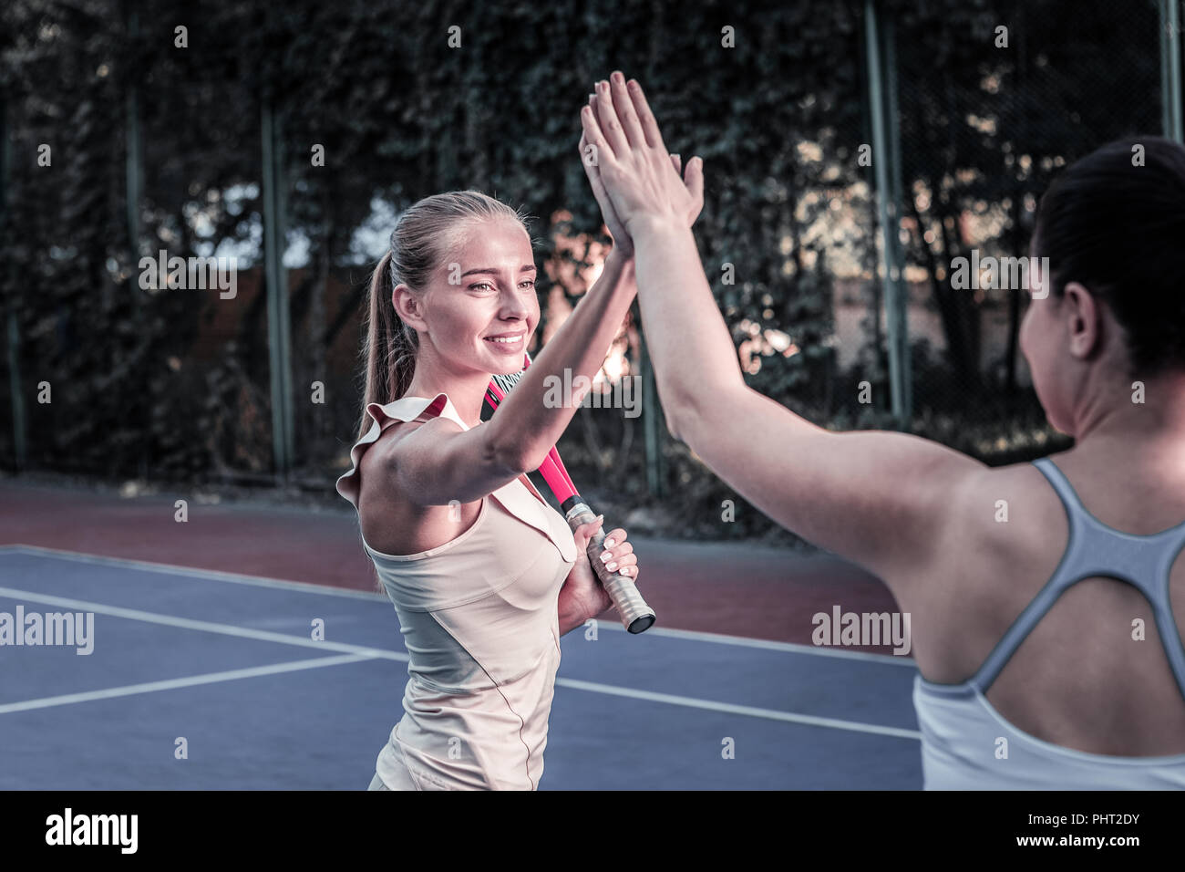 Energetic two women contesting in tennis match Stock Photo - Alamy