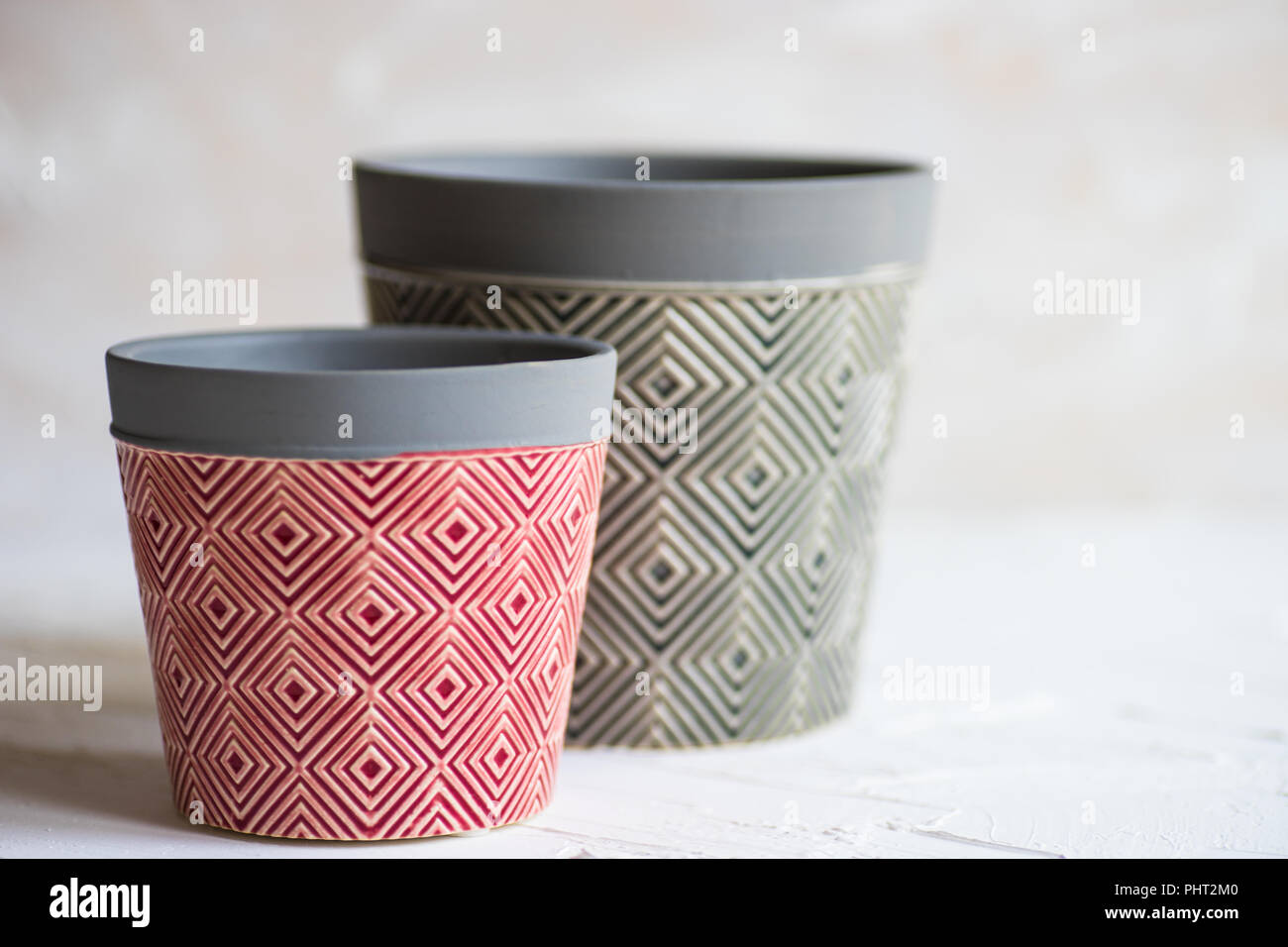 Gardening concept with empty flower pots on white concrete background ...