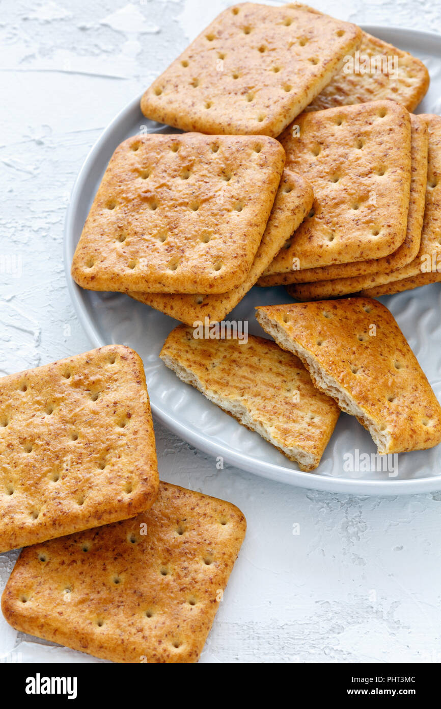 Whole grain crackers on a white plate Stock Photo - Alamy