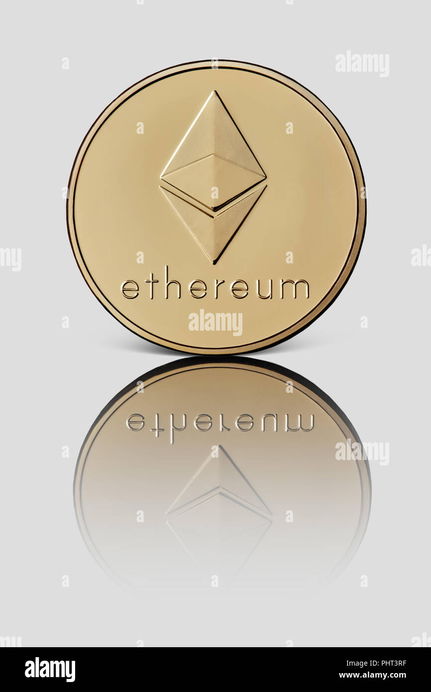 Gold coin ethereum represented on a white glossy background Stock Photo ...