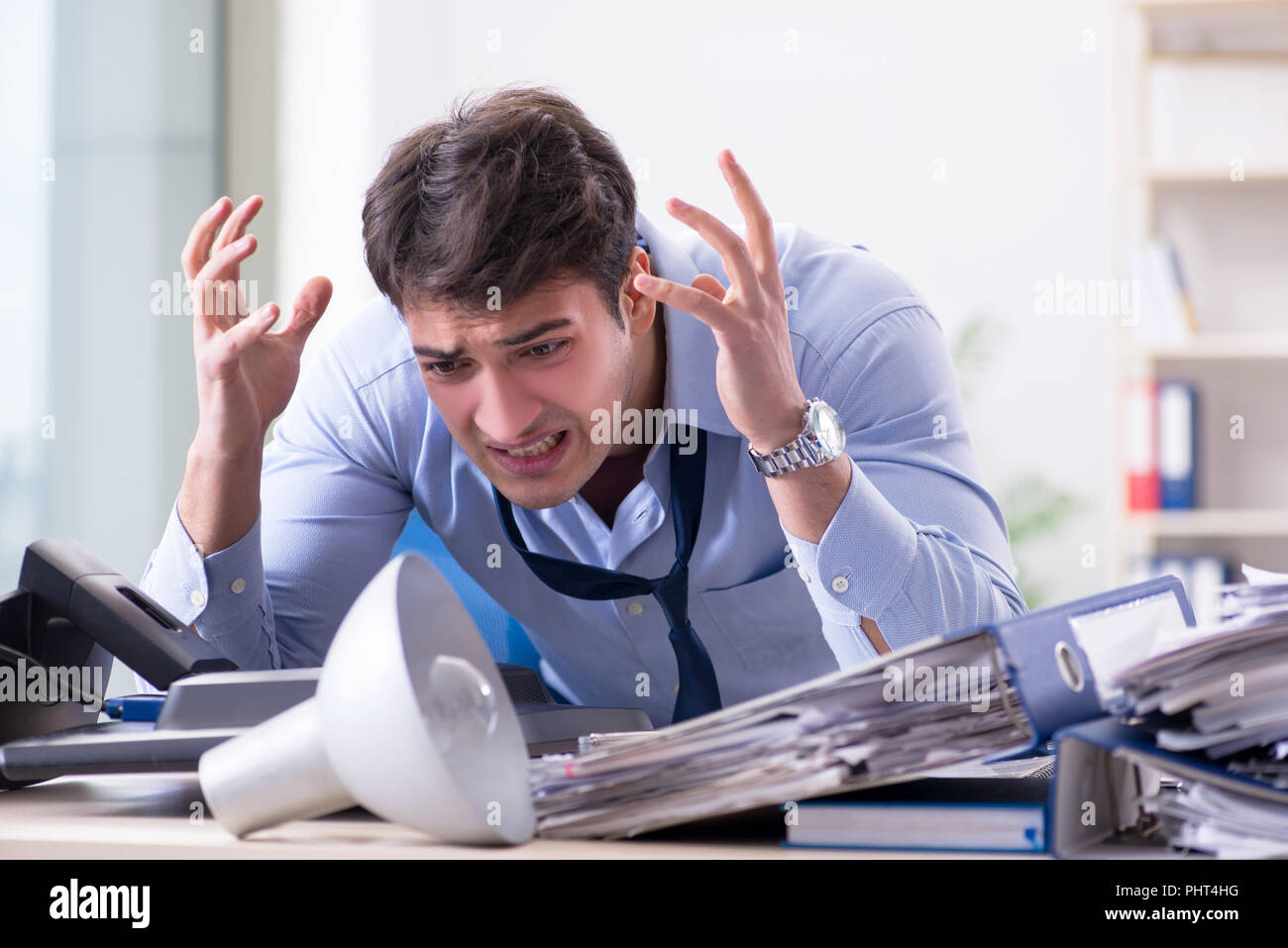 Angry businessman frustrated with too much work Stock Photo - Alamy