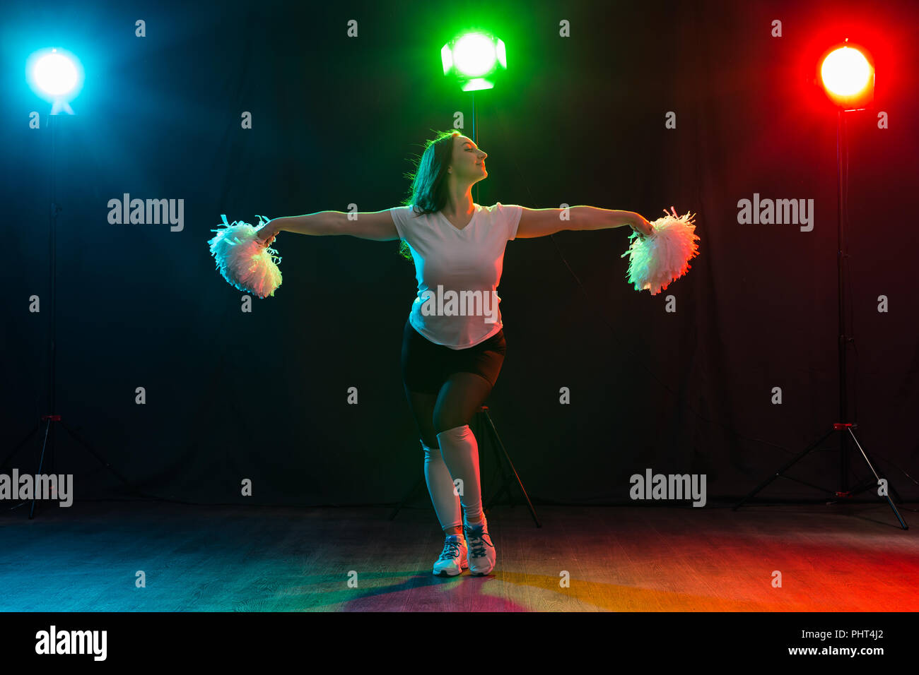 Full length portrait of cheerleader dancing with pom-poms Stock Photo ...