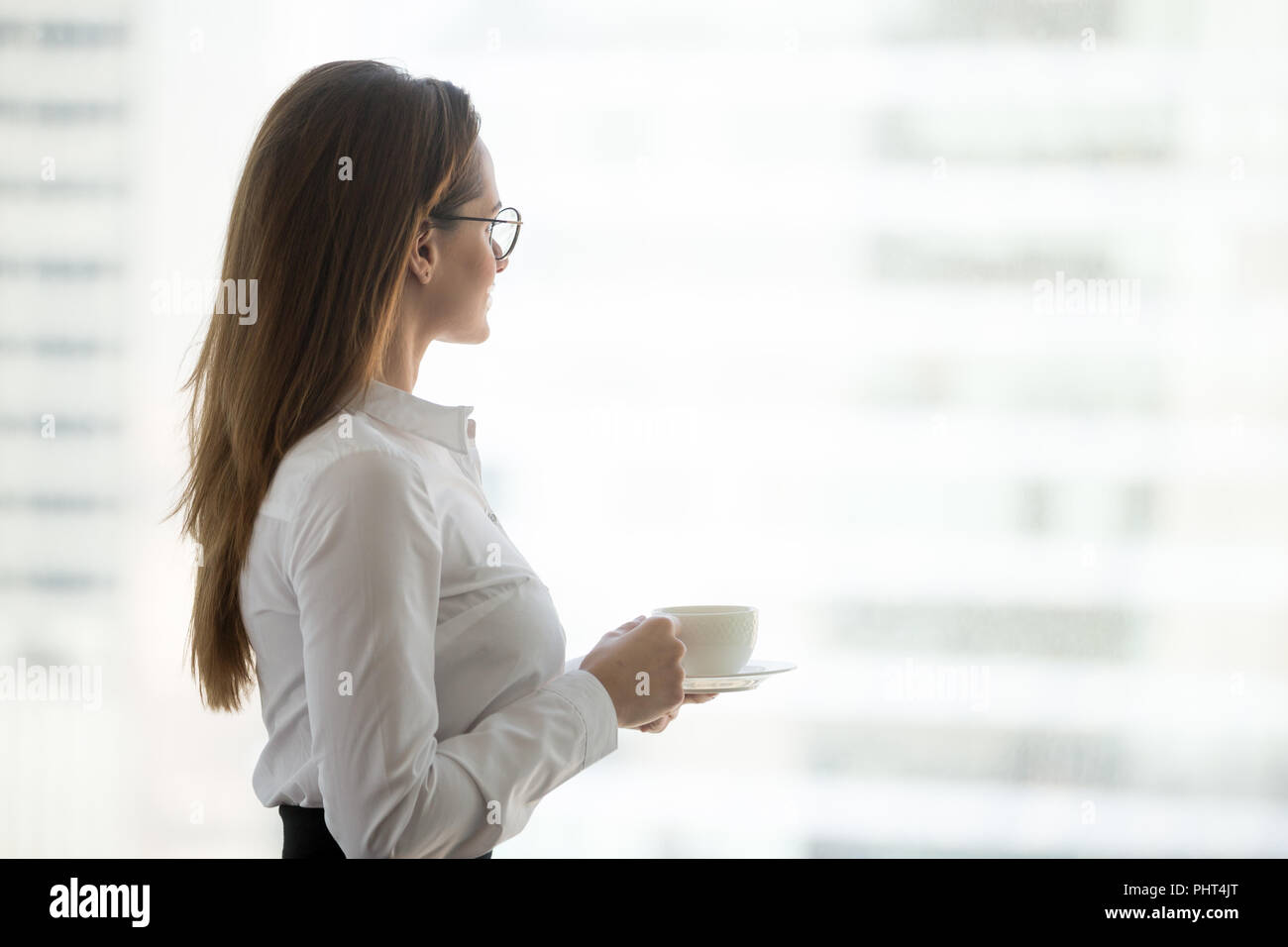 Thoughtful businesswoman looking out window thinking of future d Stock ...