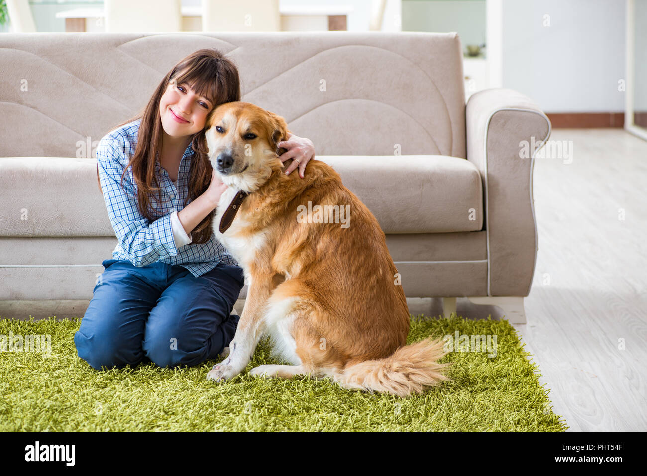 Happy woman dog owner at home with golden retriever Stock Photo - Alamy