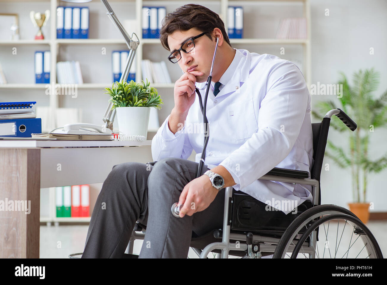 Disabled doctor on wheelchair working in hospital Stock Photo - Alamy