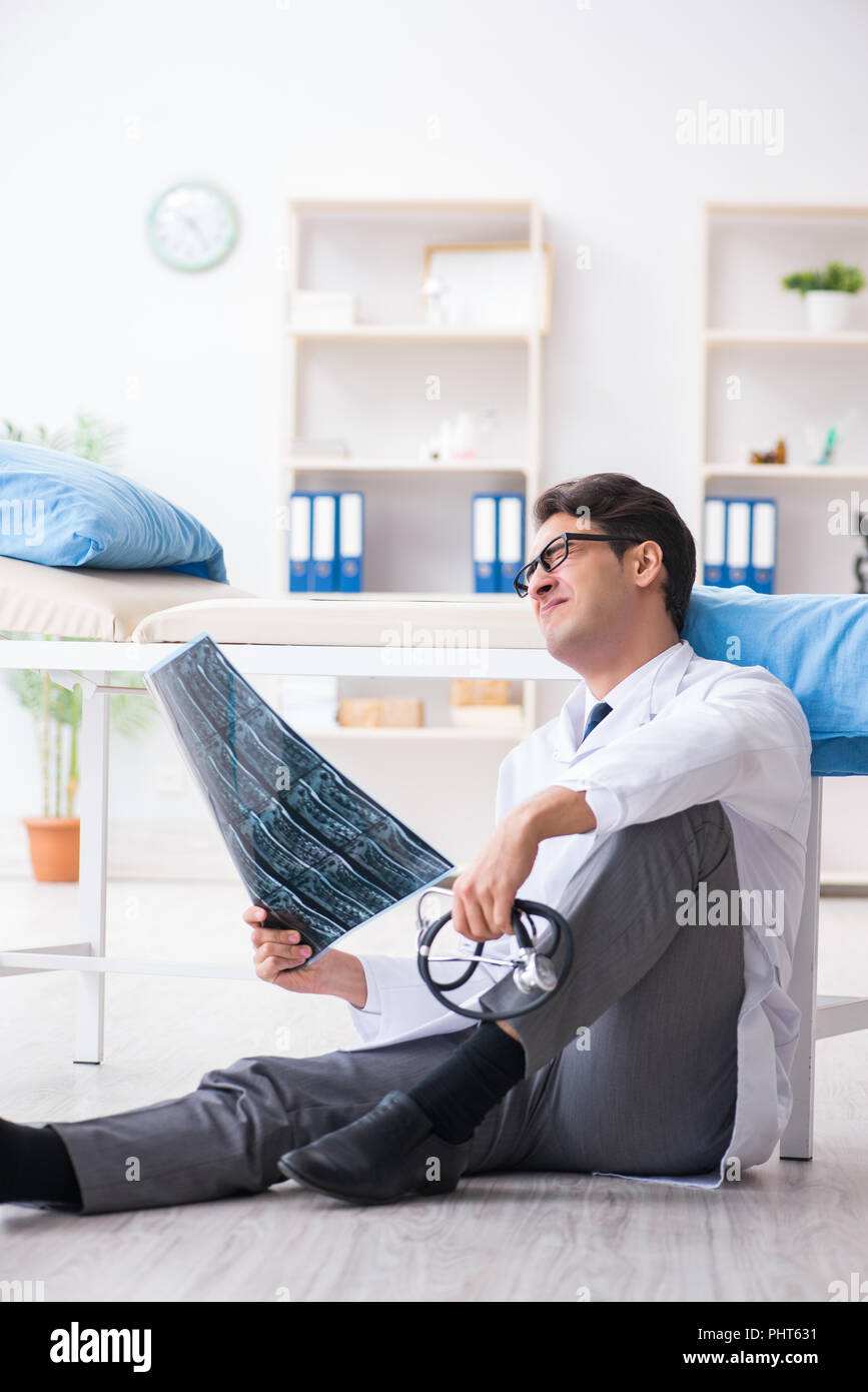 Doctor sitting on the floor in hospital Stock Photo - Alamy