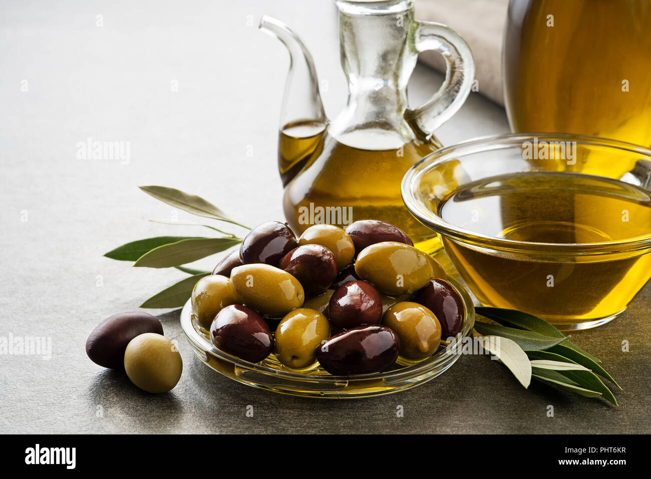 Bottle of Extra virgin healthy Olive oil with fresh olives close up ...