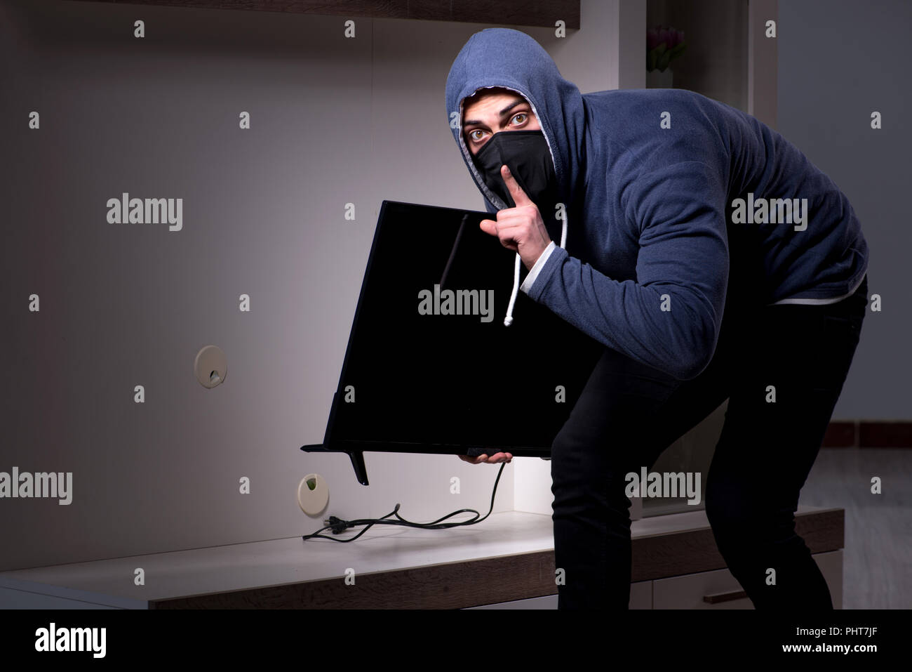 Burglar thief stealing tv from apartment house Stock Photo - Alamy