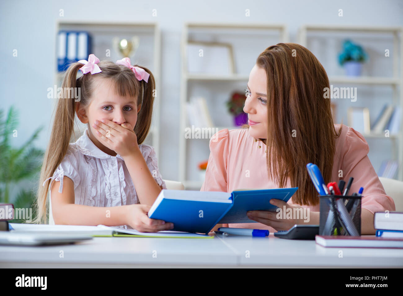Mother helping her daughter to do homework Stock Photo - Alamy