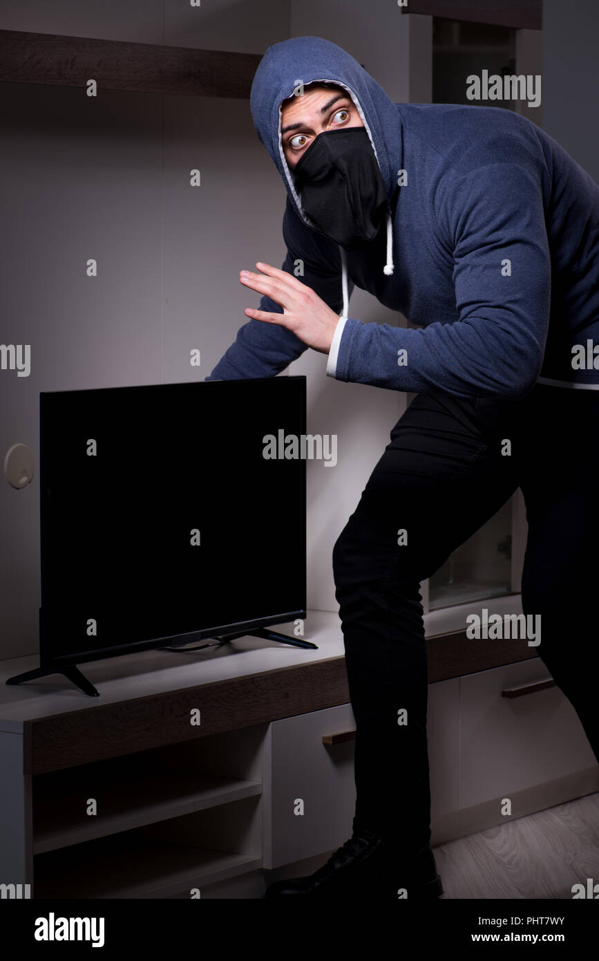 Burglar thief stealing tv from apartment house Stock Photo - Alamy