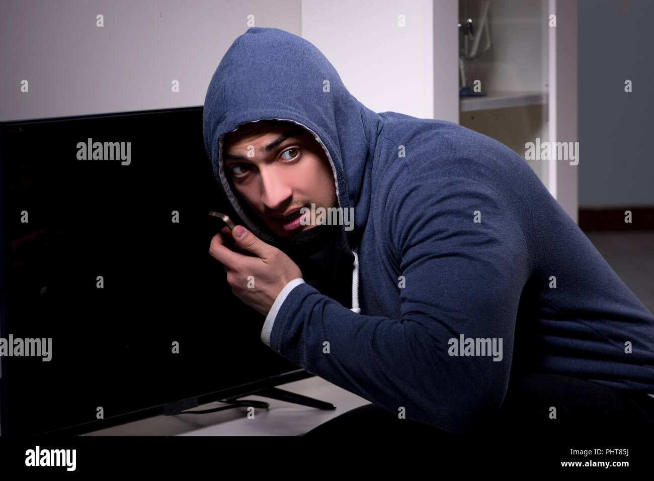 Burglar thief stealing tv from apartment house Stock Photo - Alamy