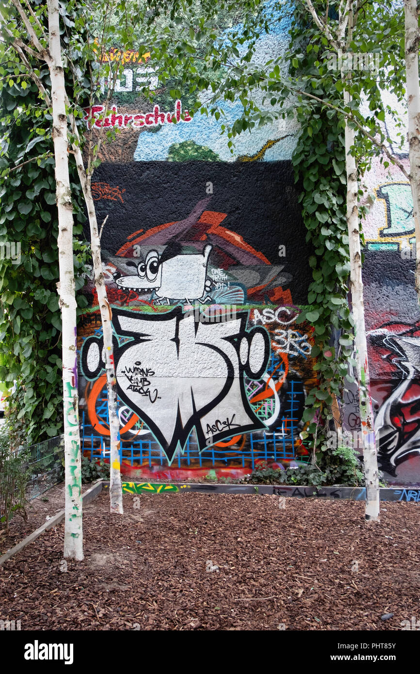 Berlin,Graffiti Corner, small park with birch trees,benches, trampoline ...