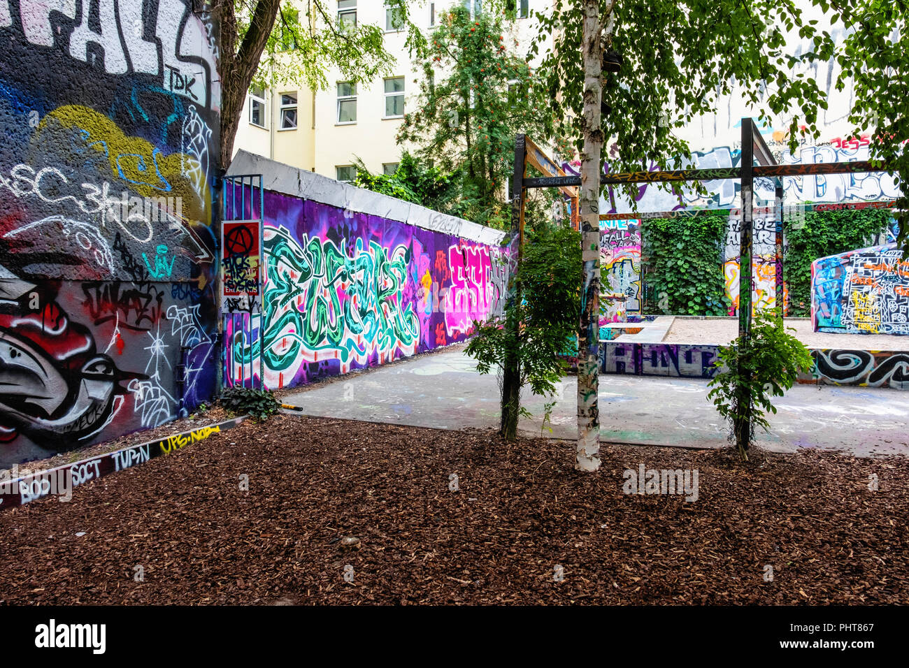 Berlin,Graffiti Corner, small park with birch trees,benches, trampoline ...
