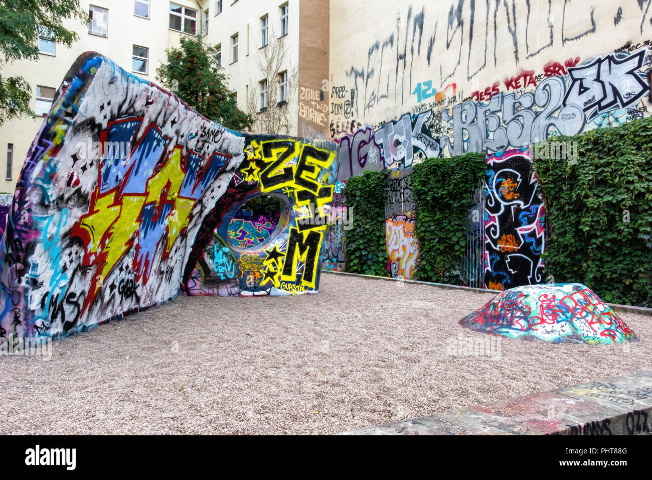 Berlin,Graffiti Corner, small park with birch trees,benches, trampoline ...