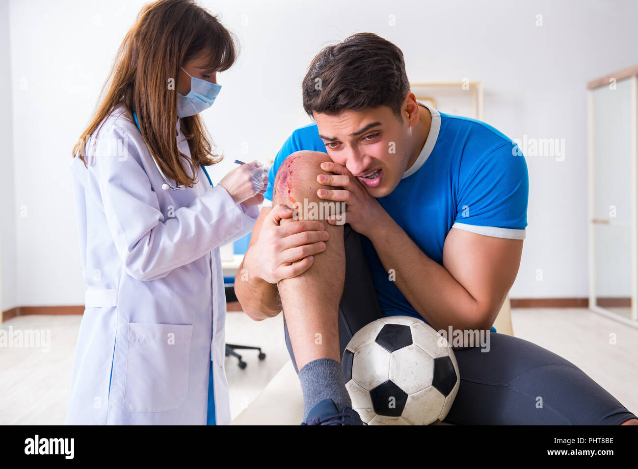 Football soccer player visiting doctor after injury Stock Photo - Alamy