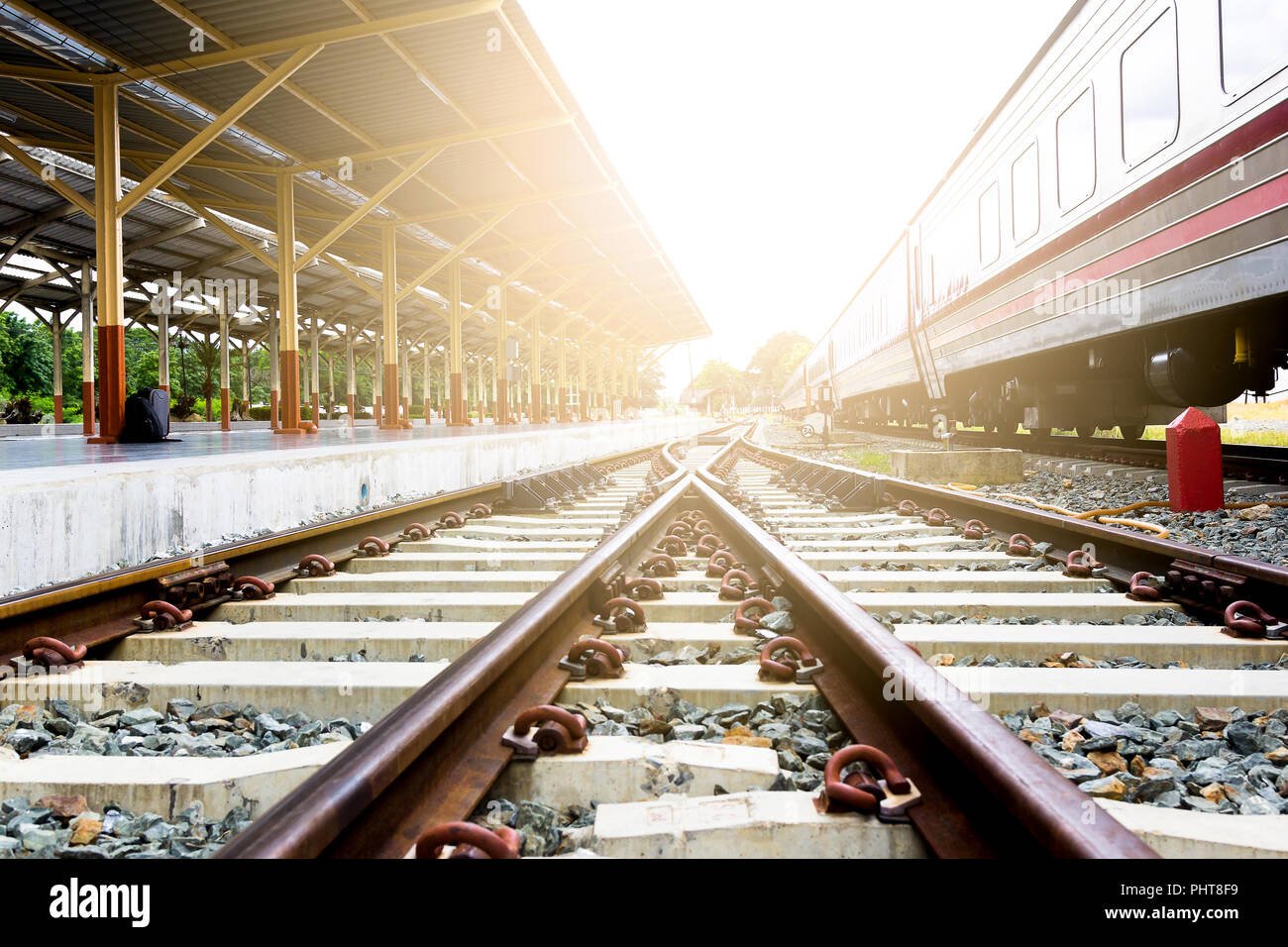 Two railway tracks merge at the railway station Stock Photo - Alamy