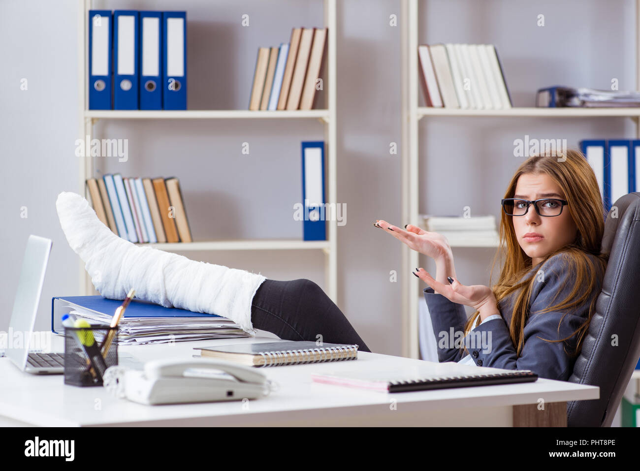 Busiesswoman employee with broken leg in office Stock Photo - Alamy