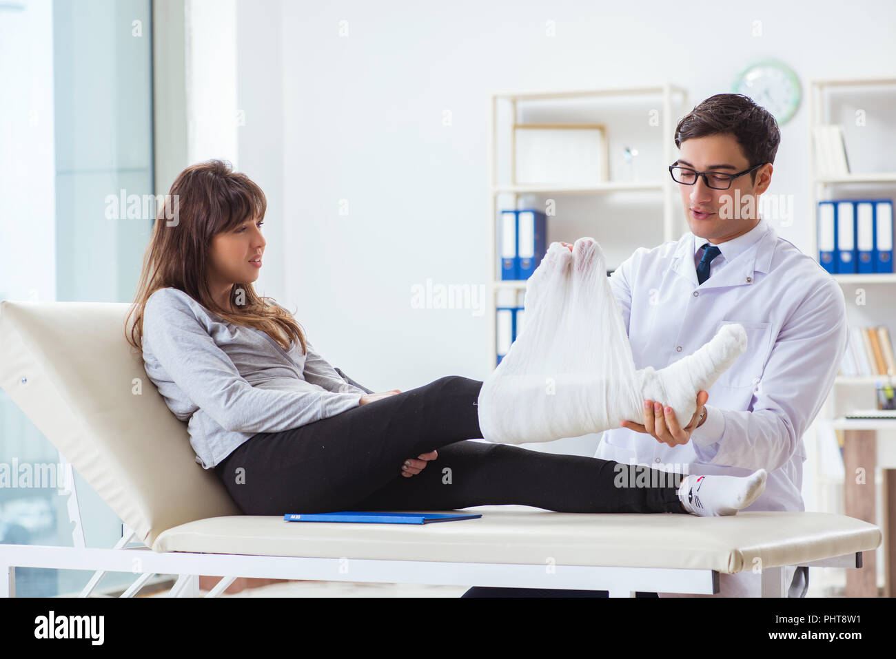 Doctor examining patient with broken leg Stock Photo - Alamy
