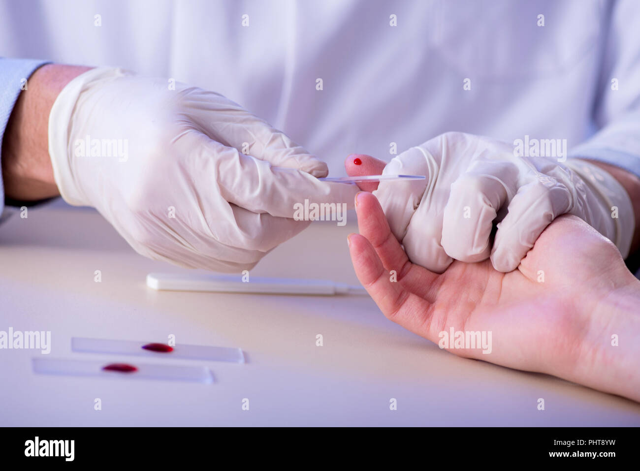 Doctor taking blood samples from finger Stock Photo - Alamy