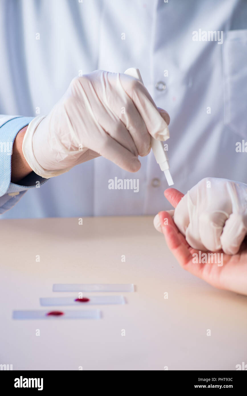 Doctor taking blood samples from finger Stock Photo - Alamy