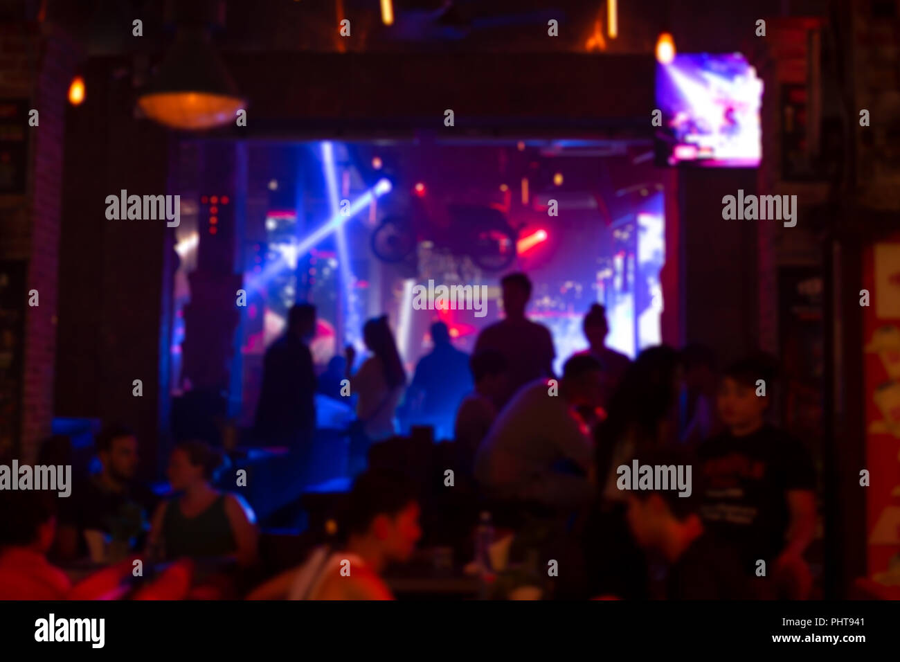 Defocused image - Blurred people with colorful laser lights inside ...
