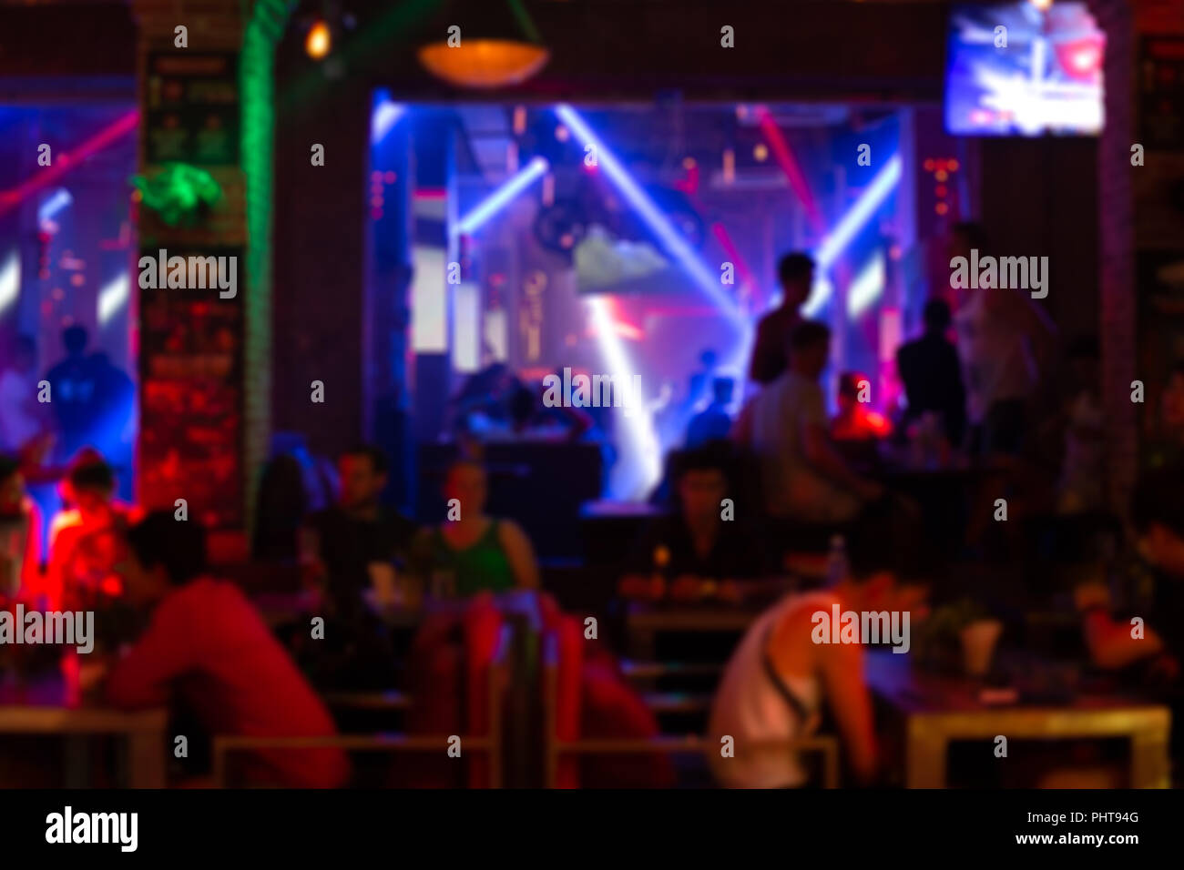 Defocused image - Blurred people with colorful laser lights inside ...