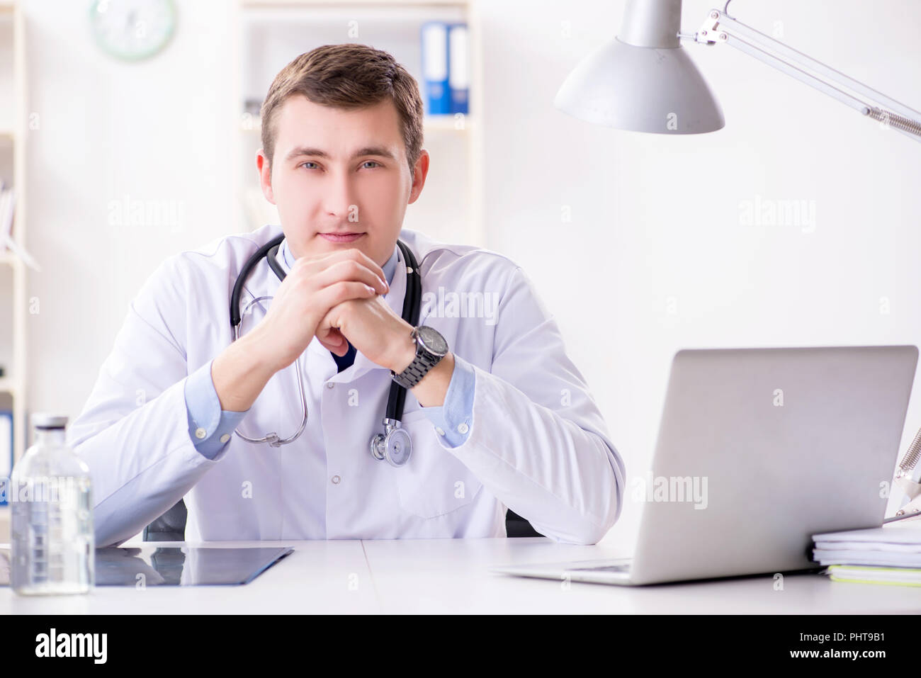 Male doctor looking at lab results in hospital Stock Photo - Alamy