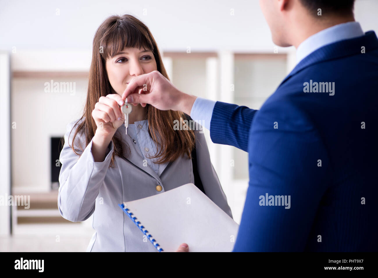 Real estate agent showing new apartment to owner Stock Photo - Alamy