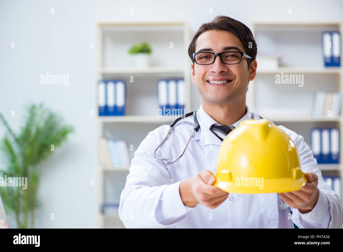 Safety doctor advising about wearing hard hat Stock Photo - Alamy