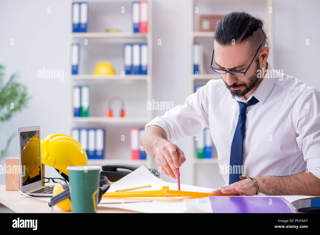 Architect working in his studio on new project Stock Photo - Alamy