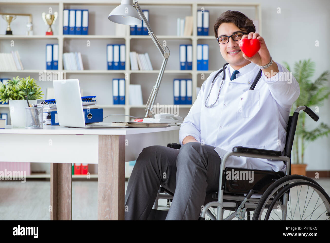 Disabled doctor on wheelchair working in hospital Stock Photo - Alamy