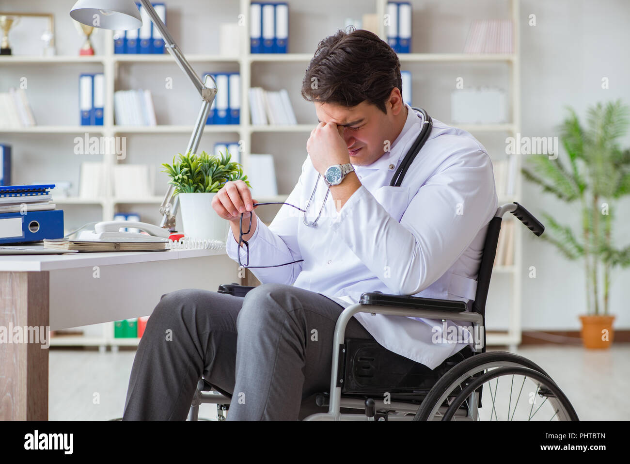 Disabled doctor on wheelchair working in hospital Stock Photo - Alamy
