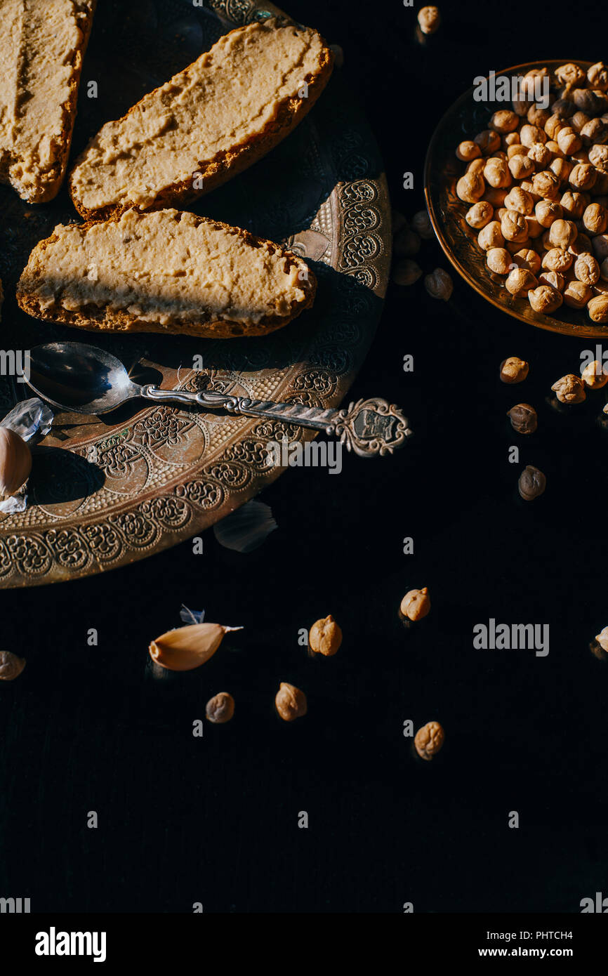 Homemade hummus on a black background Stock Photo - Alamy