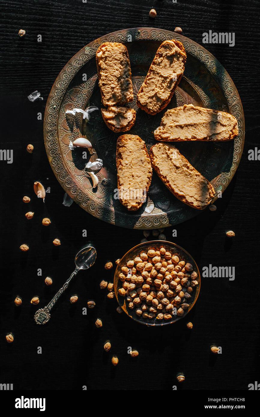 Homemade hummus on a black background Stock Photo - Alamy