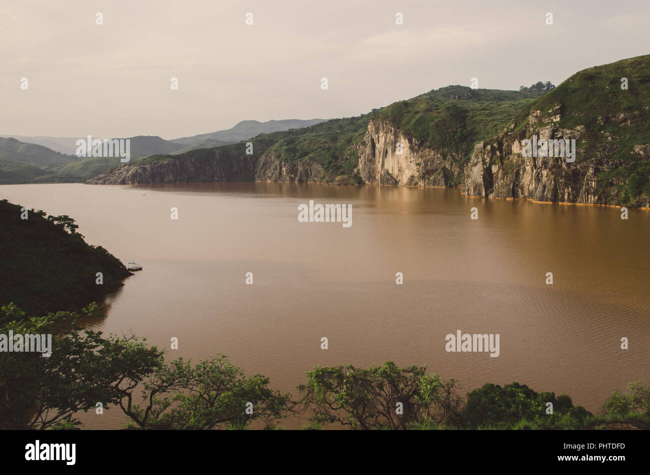 Landscape including calm brown water of Lake Nyos, famous for a CO2 ...