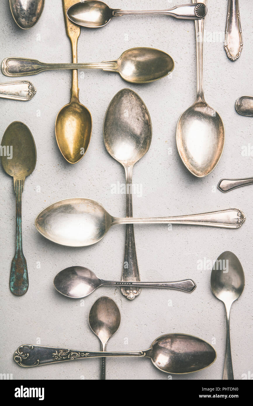 Collection of old vintage spoons on grey background Stock Photo - Alamy