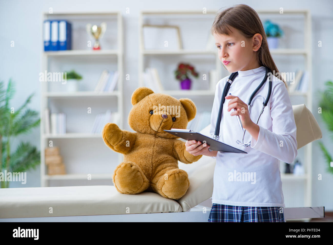 Young girl playing doctor in early development concept Stock Photo - Alamy