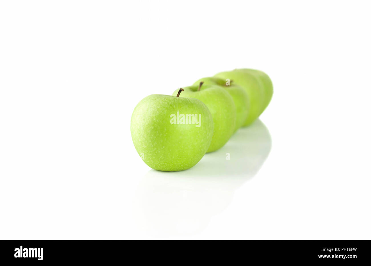 Green apple in a line isolated Stock Photo - Alamy