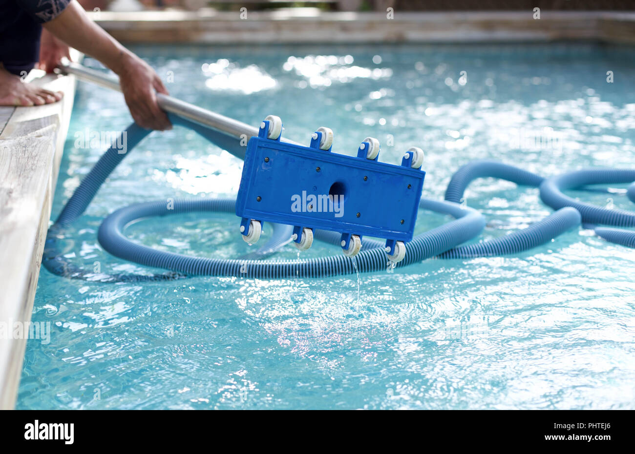 Man holding an equipment for cleaning swimming pool Stock Photo - Alamy