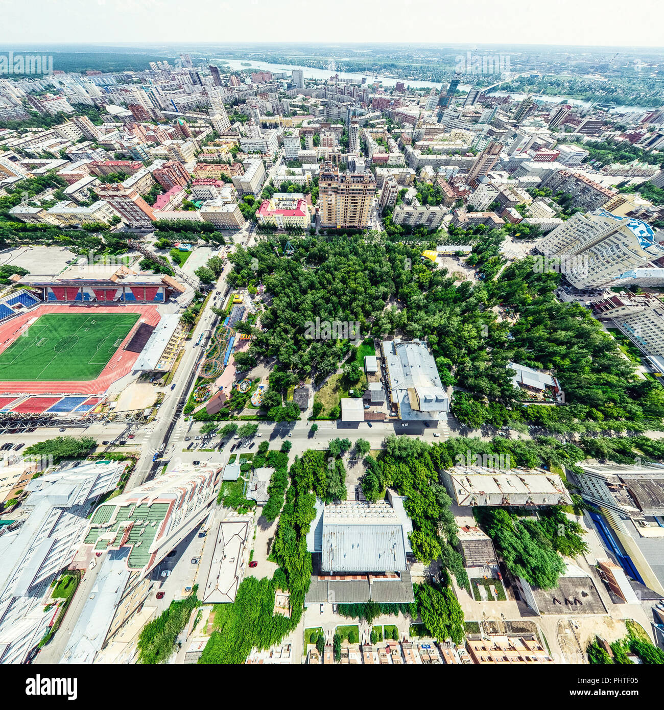 Aerial city view with crossroads and roads, houses, buildings, parks ...