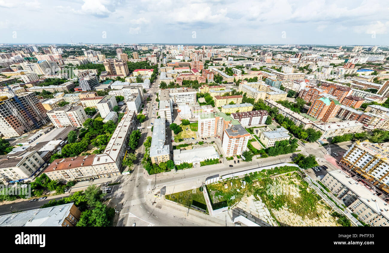 Aerial city view with crossroads and roads, houses, buildings, parks ...