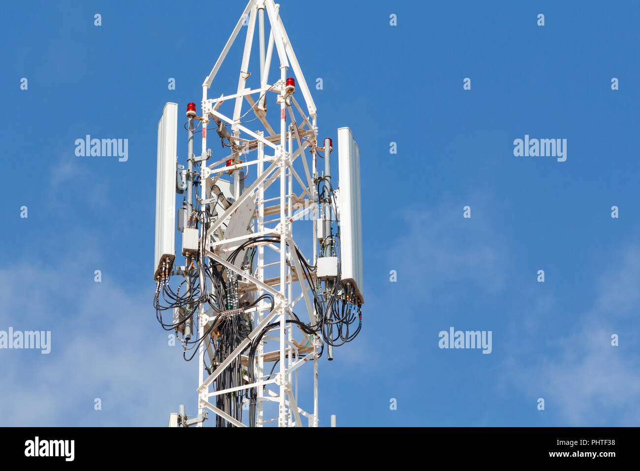 Telecommunications tower against blue sky, with mobile antennas Stock Photo - Alamy