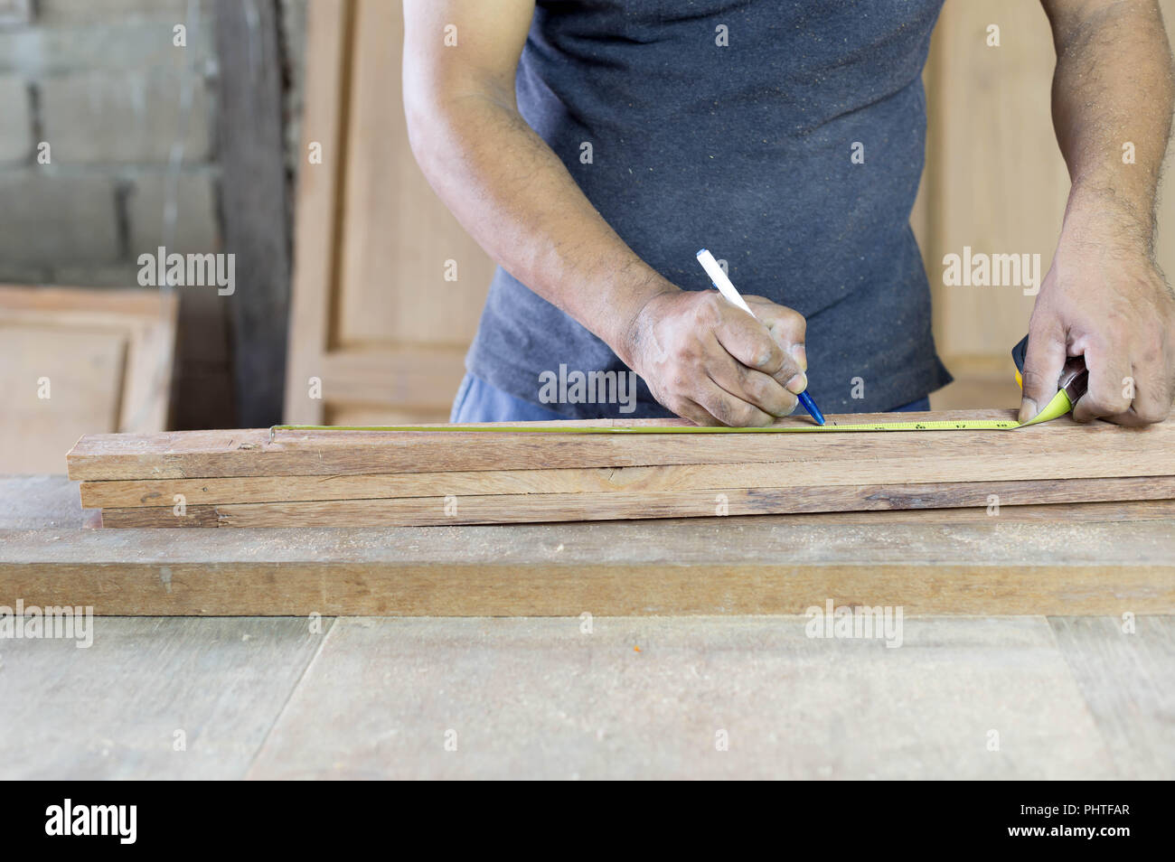 Male carpenter measuring wood in his workshop Stock Photo - Alamy