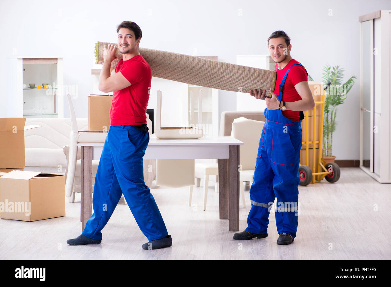Two contractor employees moving personal belongings Stock Photo - Alamy