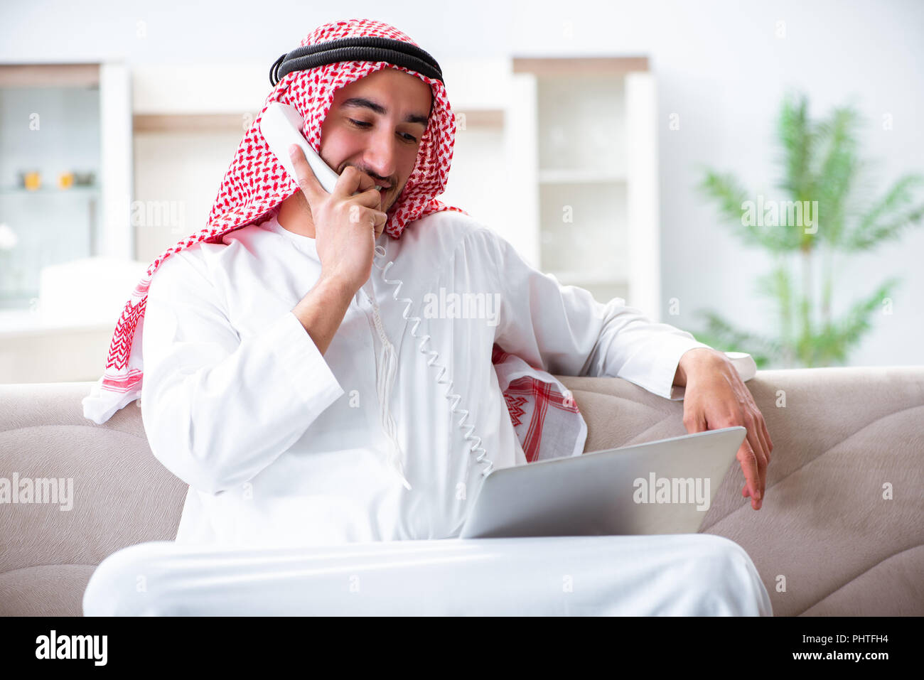 Arab man working at home on his work Stock Photo - Alamy